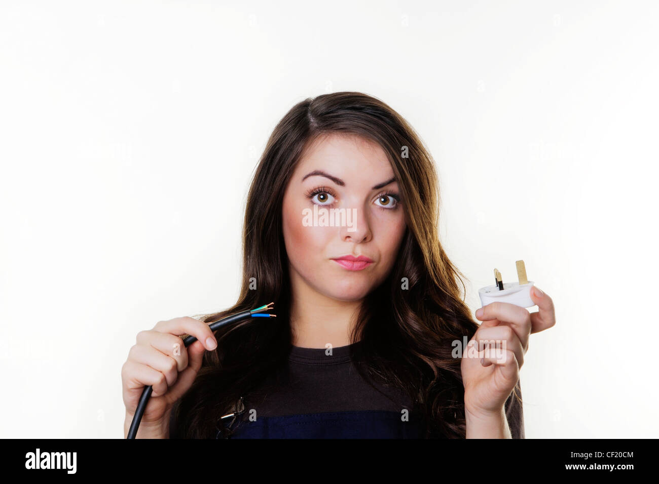 young woman not sure how to wire in a plug Stock Photo - Alamy