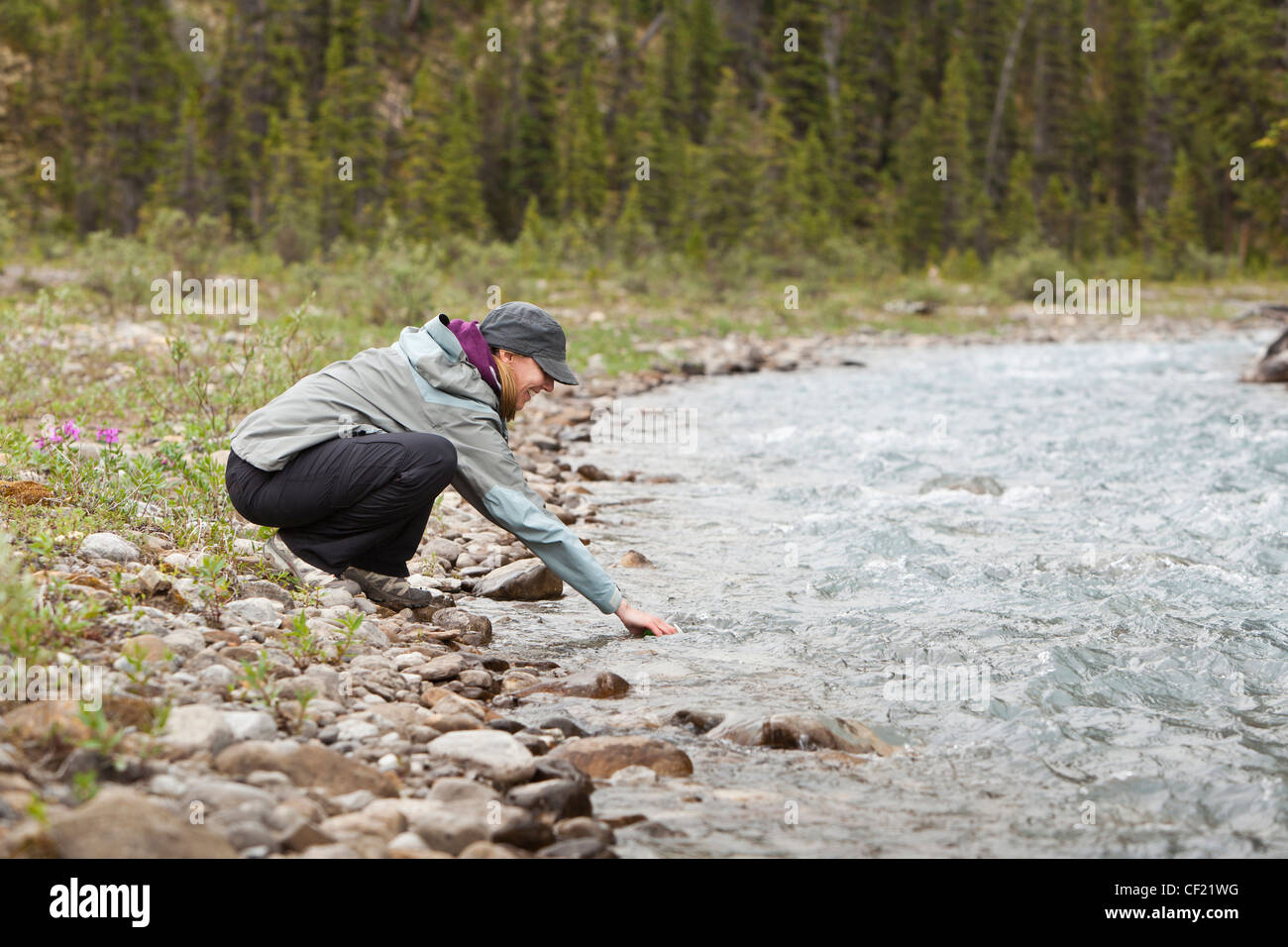 Woman getting creek water hi-res stock photography and images - Alamy
