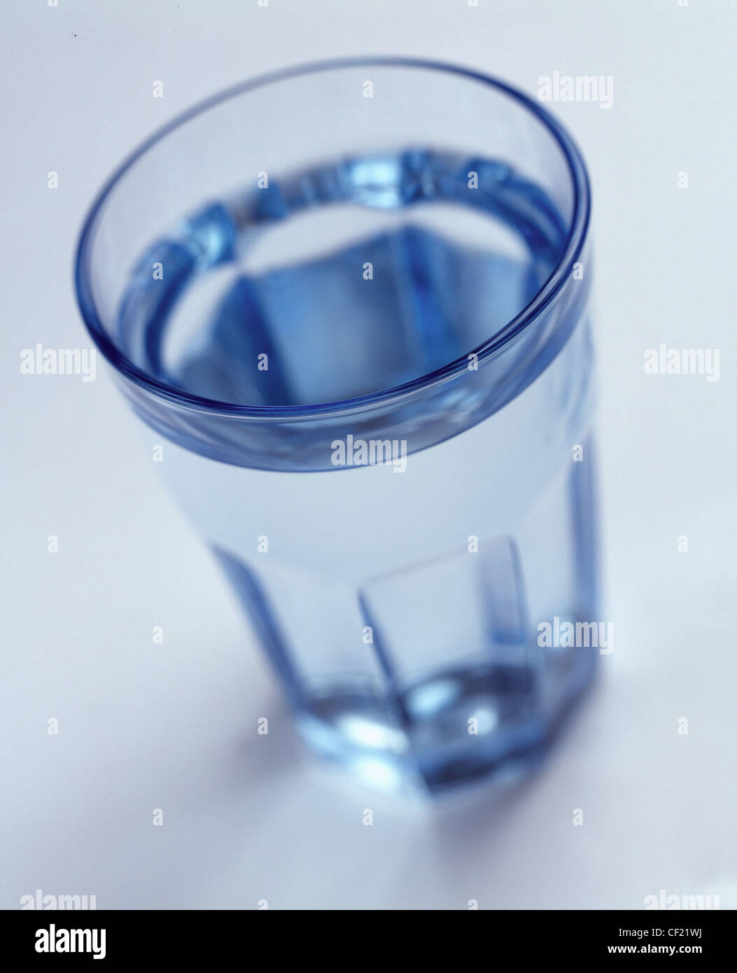 Aerial view of glass of water on blue background Stock Photo - Alamy