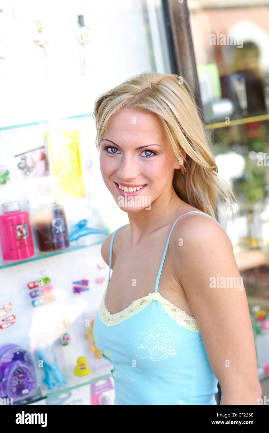 Female Shoulder Length Straight Blonde Hair Wearing Pale Blue Vest Top