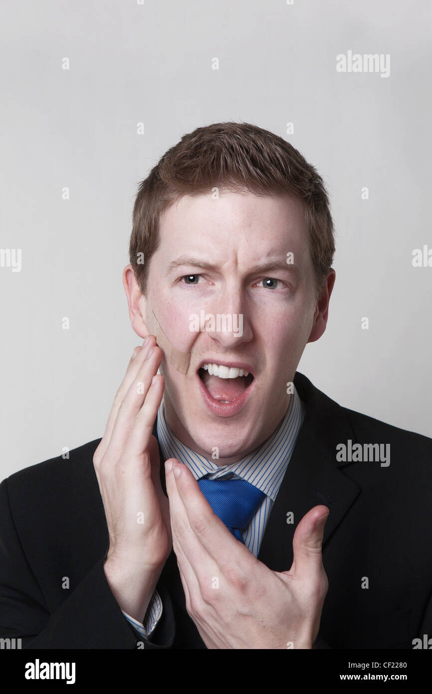 businessman with plasters on his face looking hurt and unhappy Stock ...