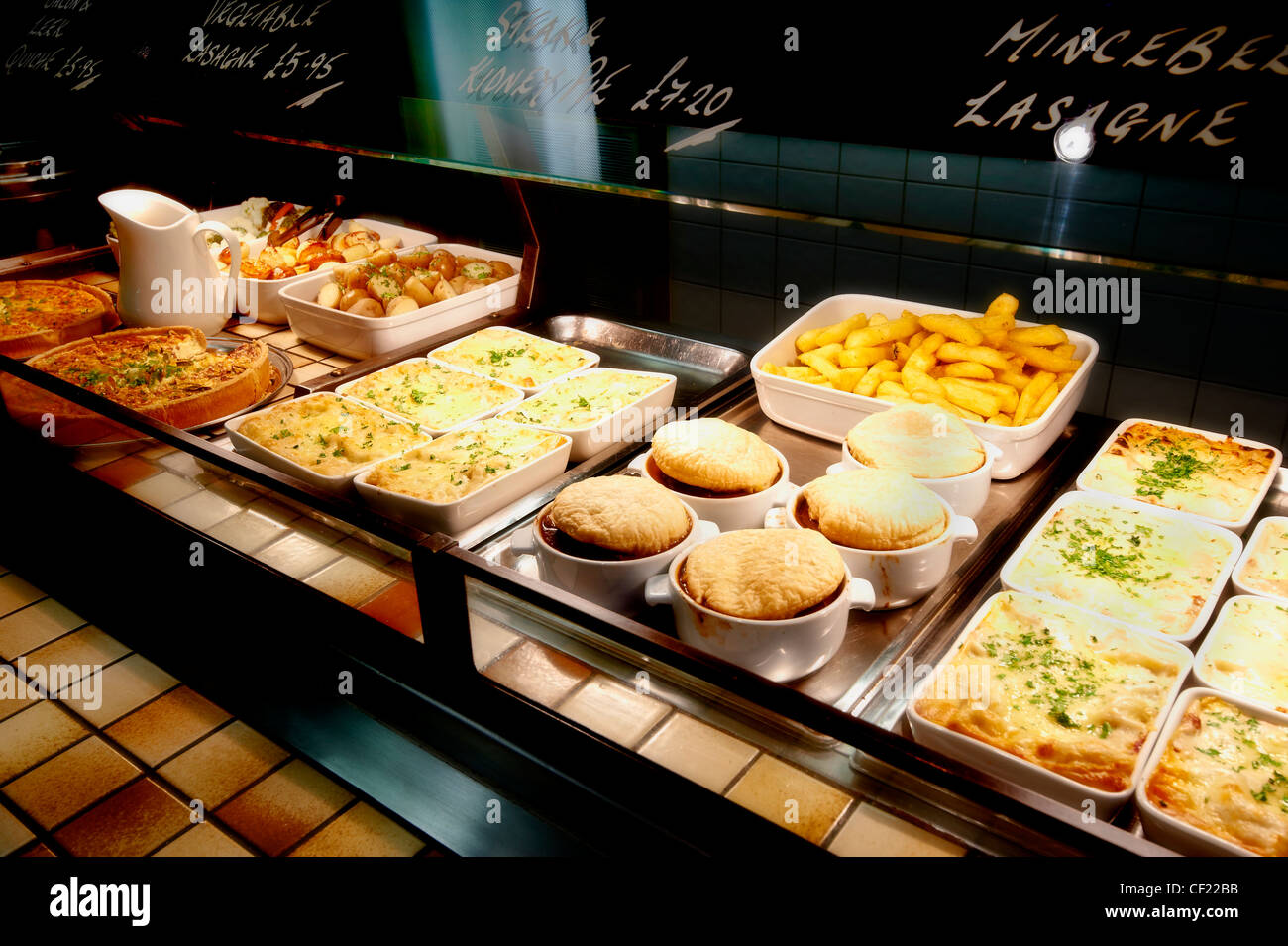 Hot food servery showing a range of pies and vegetables Stock Photo - Alamy