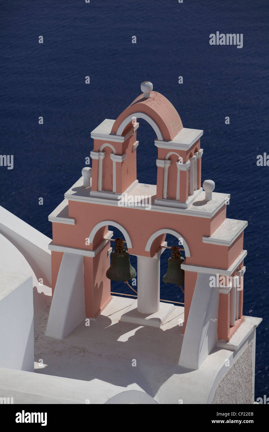 A view of a pink painted bell tower perched on a church roof with the ...