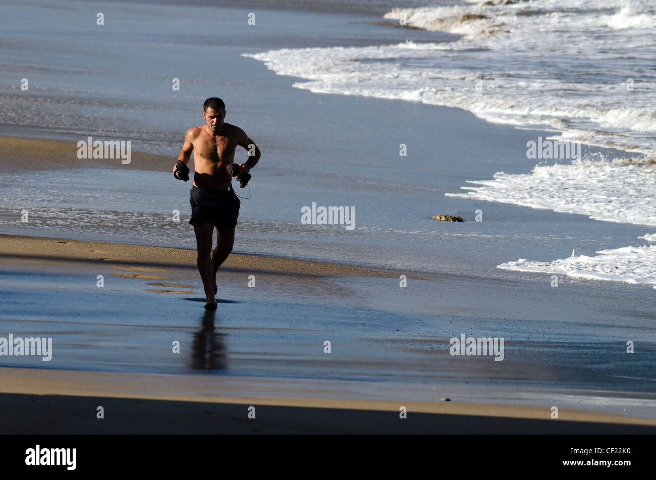Running in the beach hi-res stock photography and images - Alamy