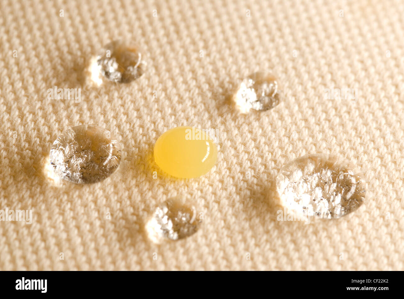 Water drops on canvas surrounding an orange drop still life Stock Photo ...