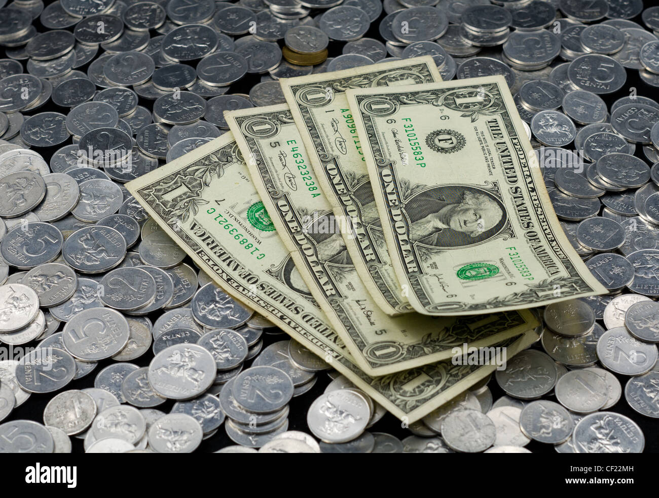 Several dollar banknotes on the coins background Stock Photo - Alamy
