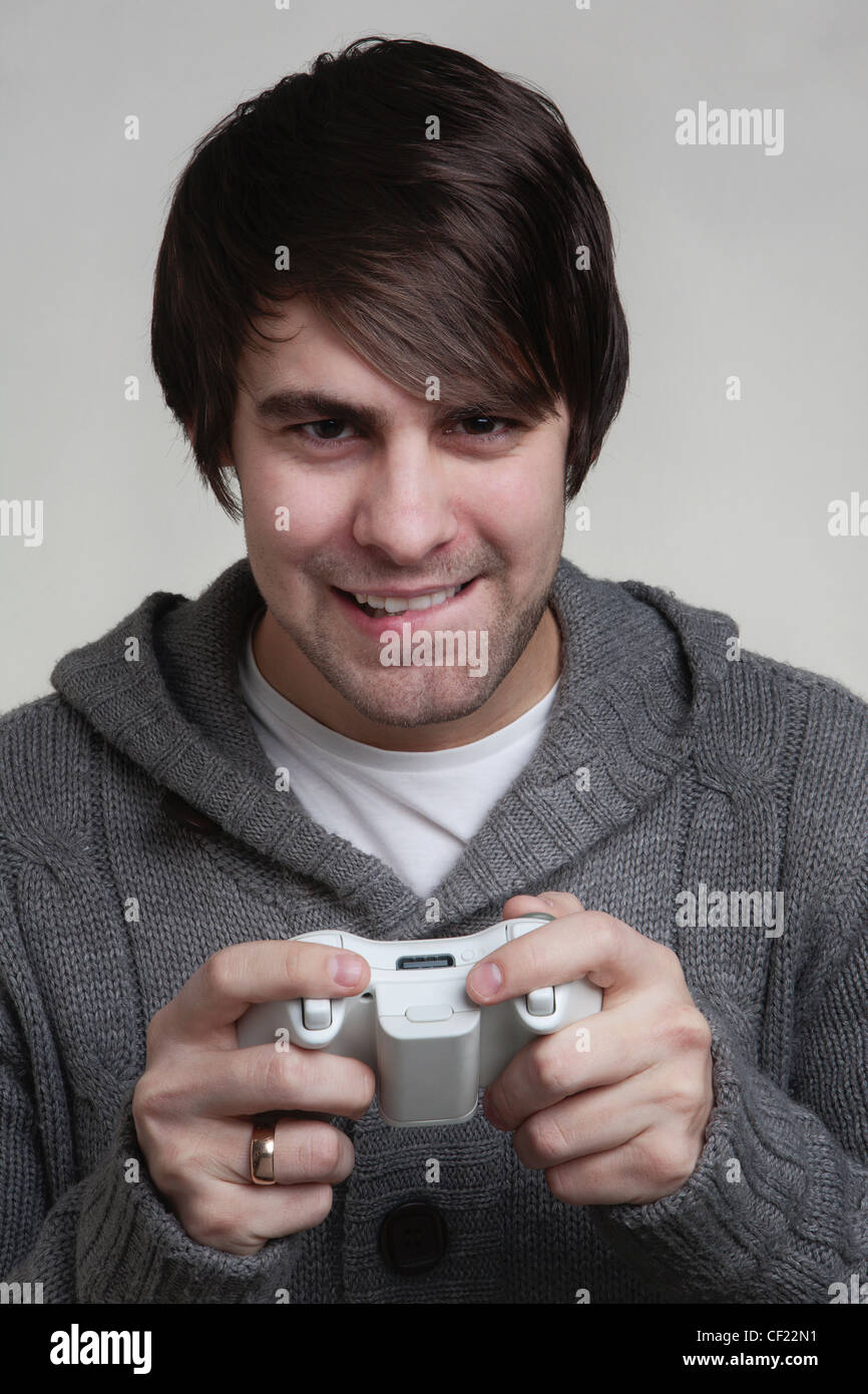 young guy playing a video game Stock Photo - Alamy