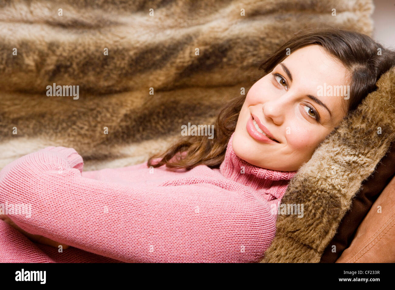 Woman laying on fur blanket hi-res stock photography and images - Alamy