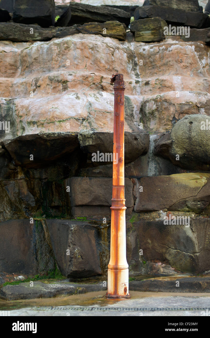 Rusty post against cliff face Stock Photo - Alamy