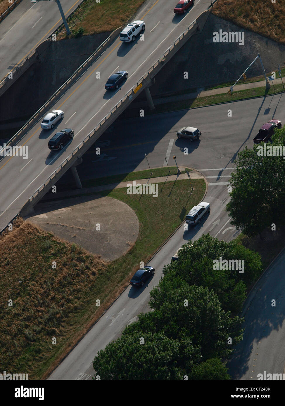 Coming off the expressway a car makes a left turn to go under the ...