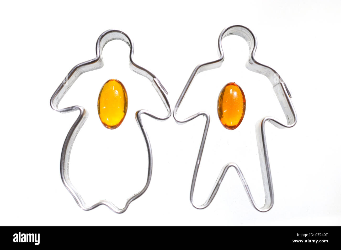 Metal gingerbread man and woman cutters with clear yellow capsule ...
