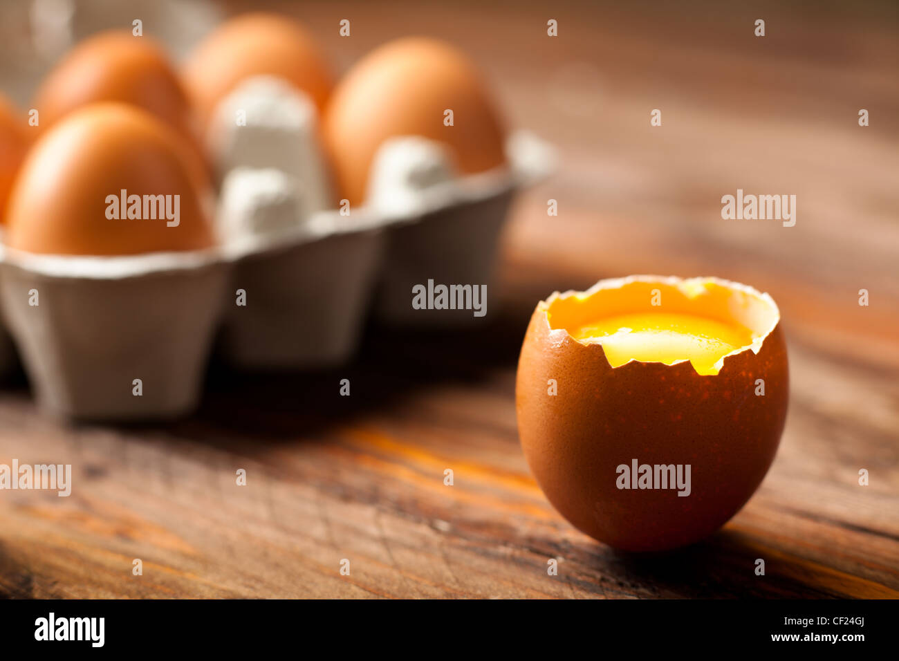 Opened Egg Shell with Yolk on Wood Stock Photo - Alamy