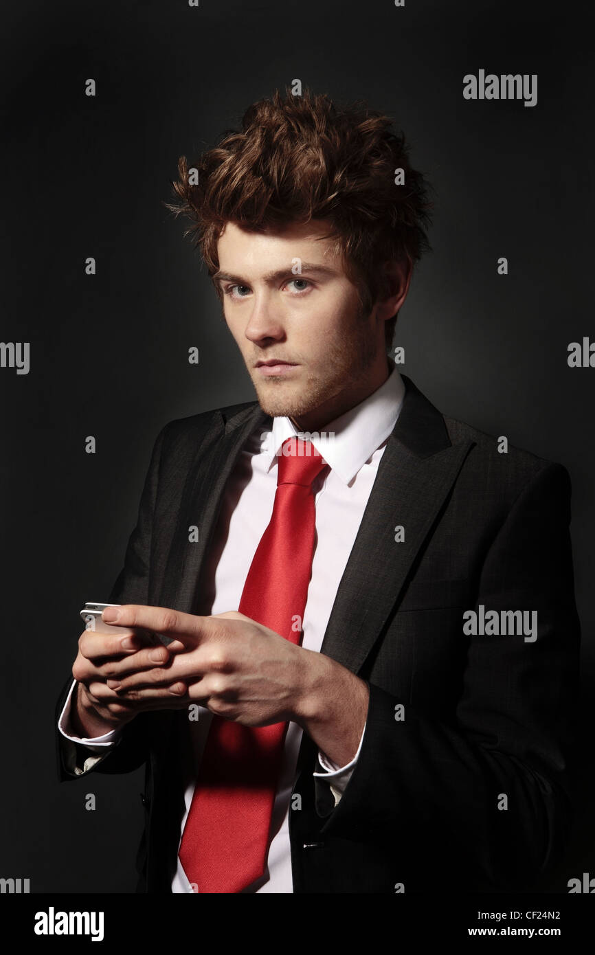 low key portrait image of a man texting on his phone Stock Photo - Alamy