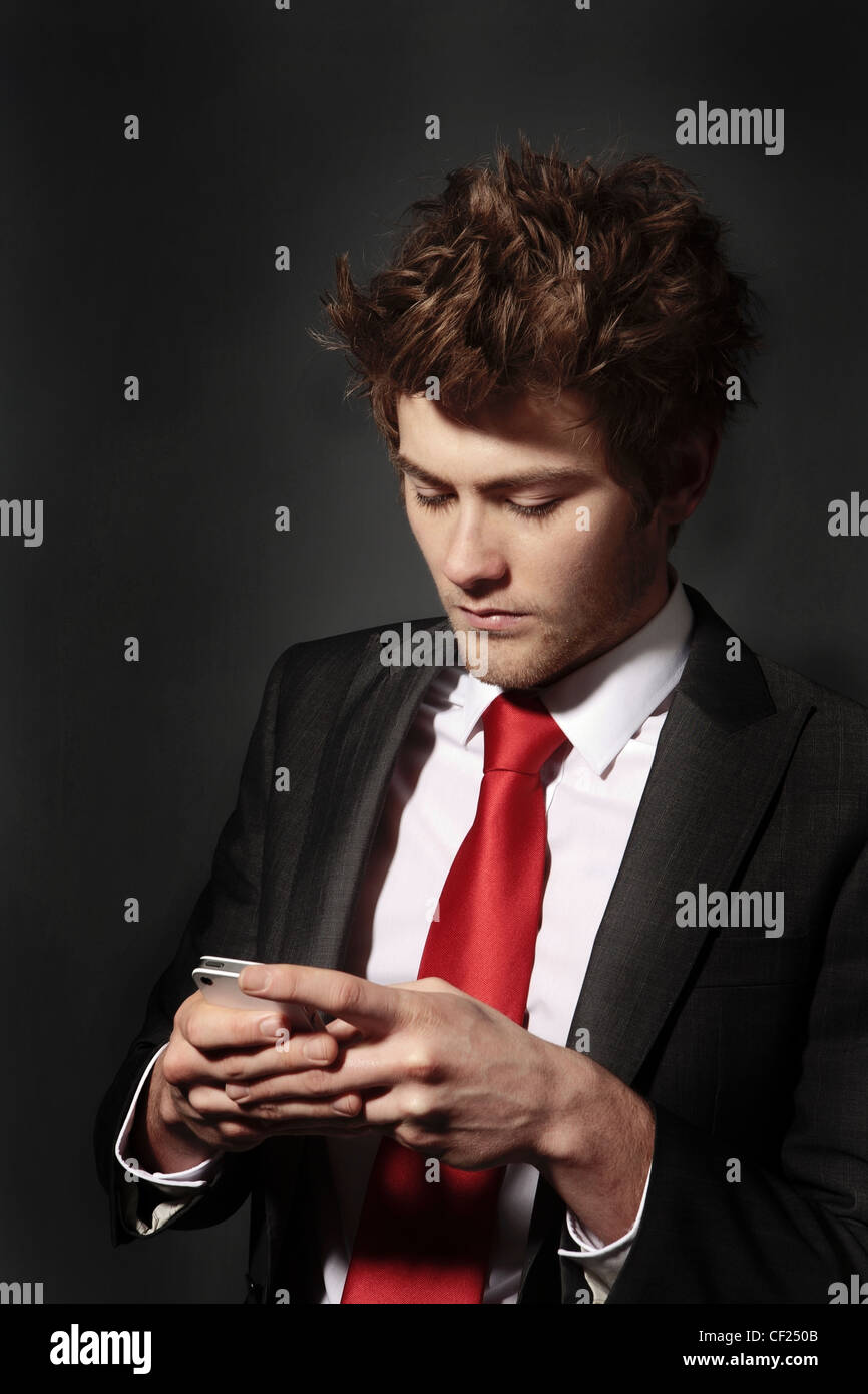 low key portrait image of a man texting on his phone Stock Photo - Alamy