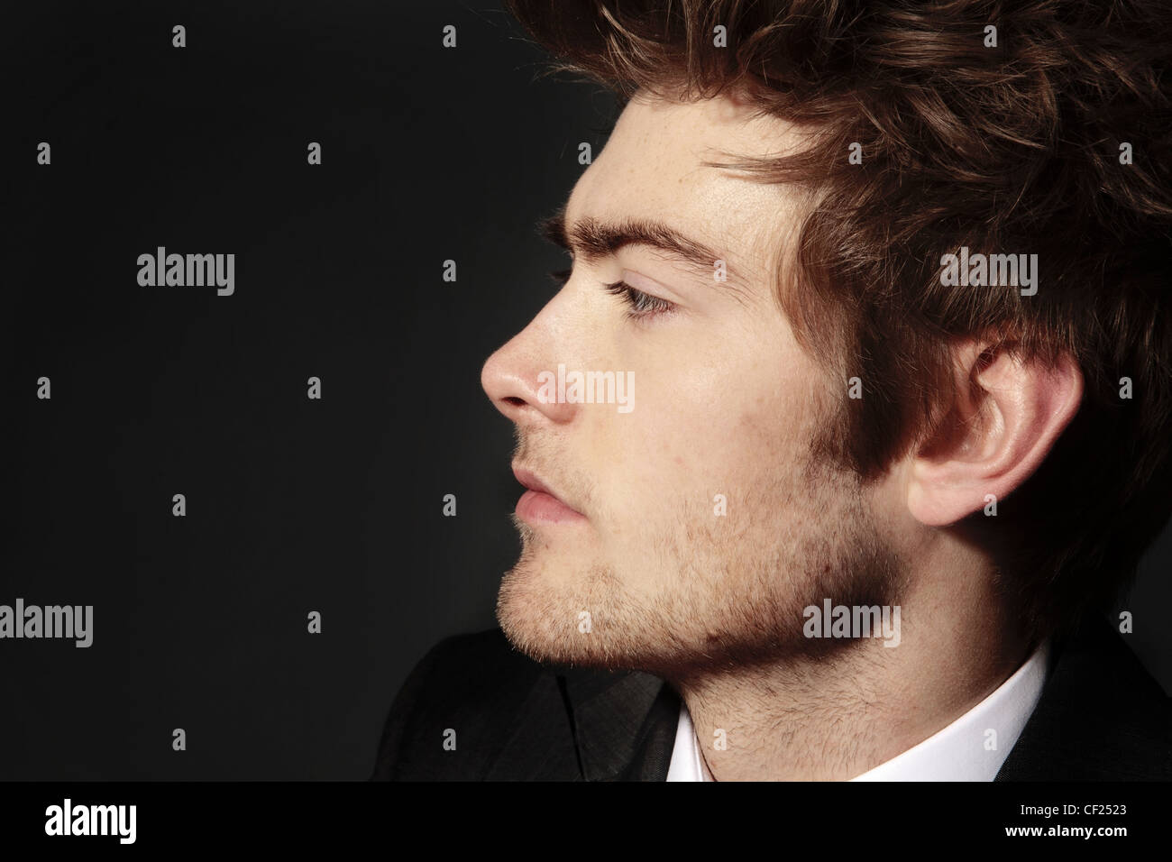 low key image of side profile of a young man Stock Photo - Alamy