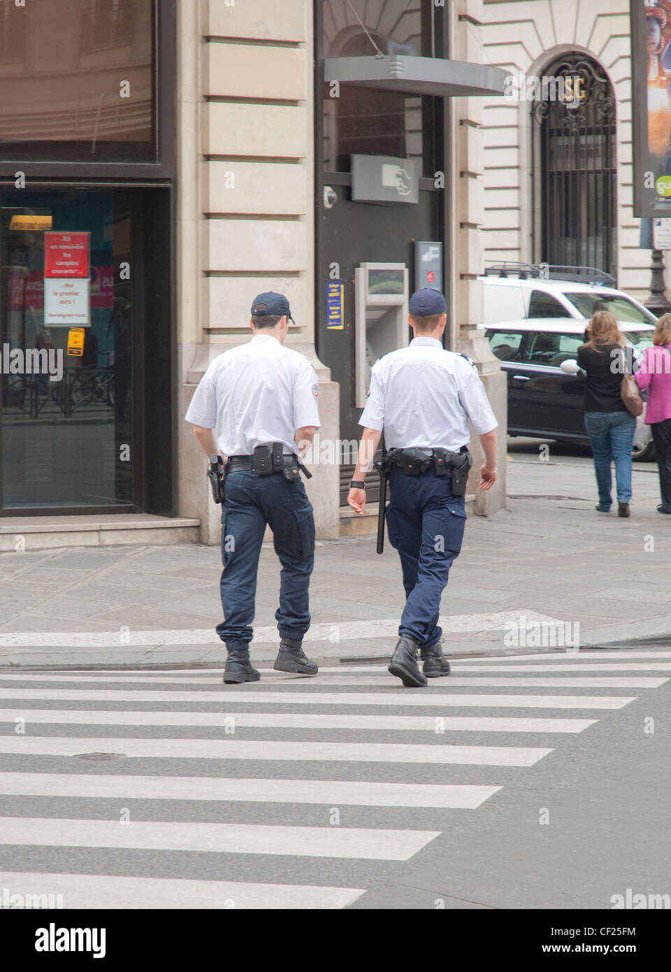 two policemen on foot patrol in central paris france Stock Photo - Alamy