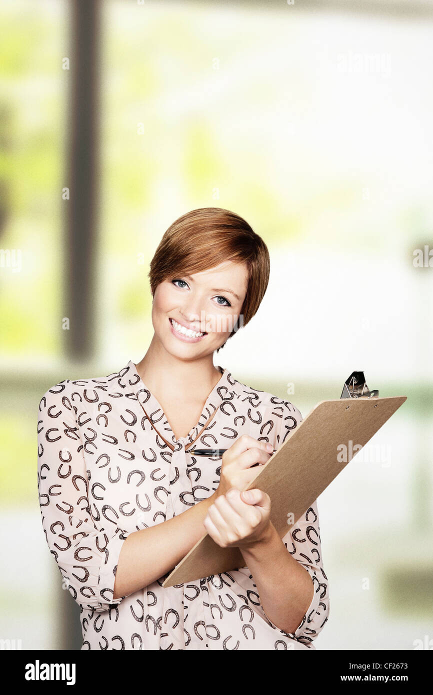 Person holding blank clip board hi-res stock photography and images - Alamy