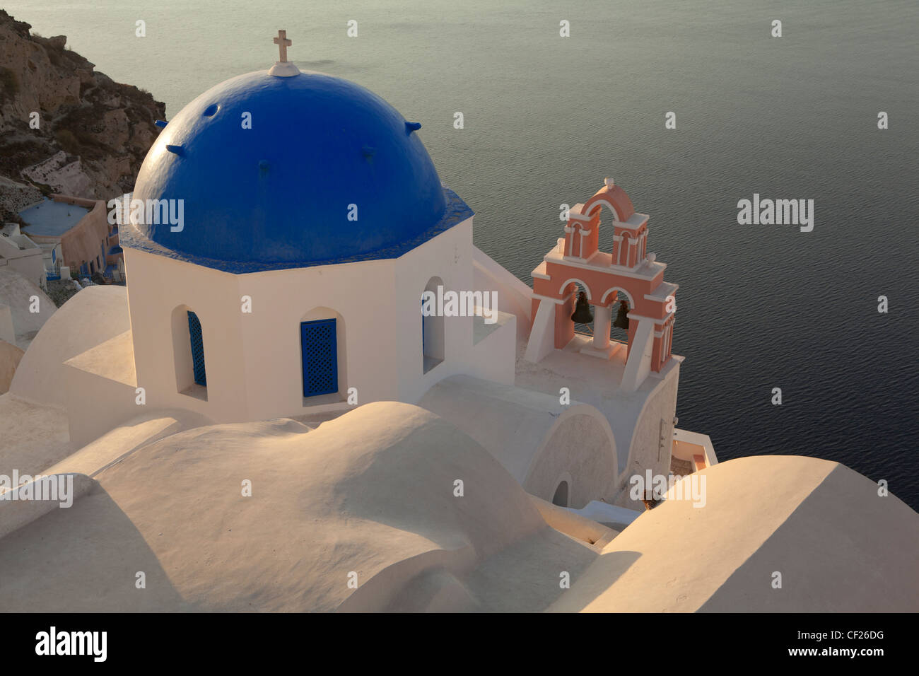A view of a traditional blue domed church and a pink bell tower with ...