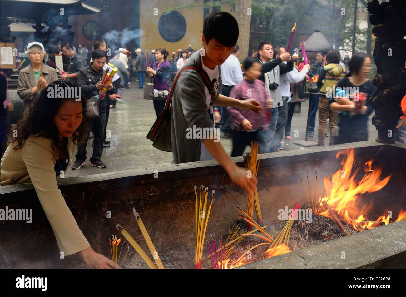 People praying for blessings placing incense sticks at the Ling Yin ...