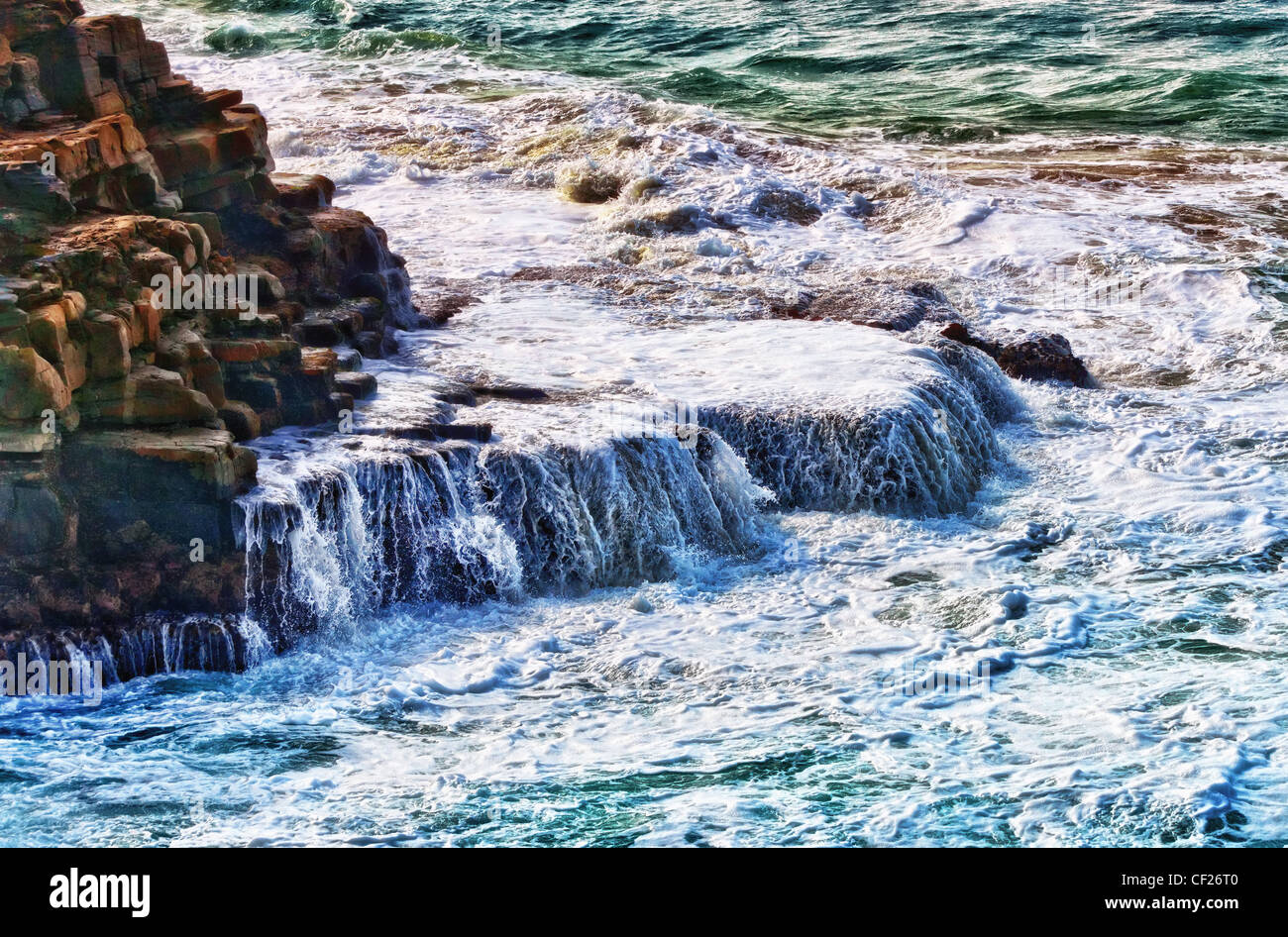 ocean waves crash on to rocks at the coast Stock Photo - Alamy