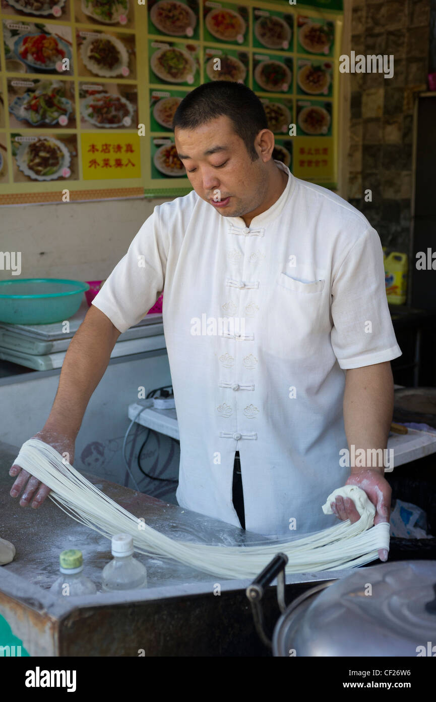 Stretching noodles. Nanshan Buddhism Culture Park. Sanya, Hainan ...