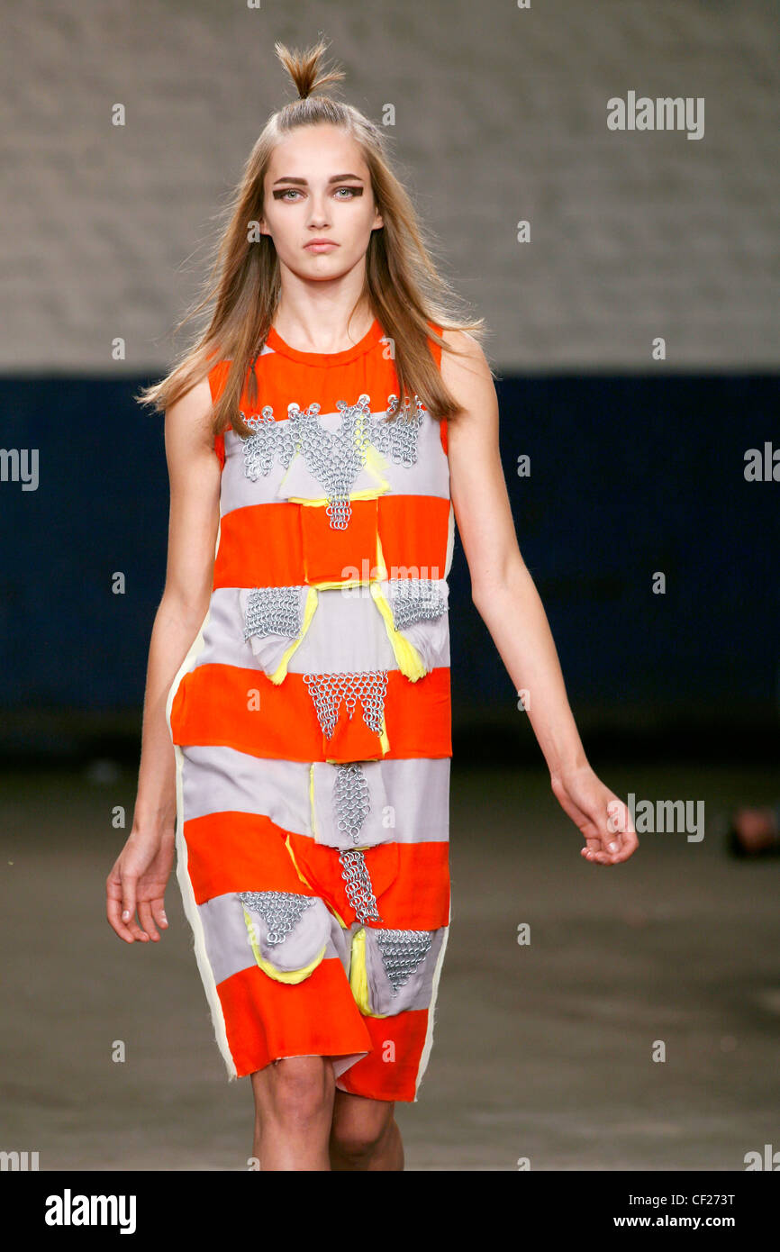 Mini ponytail, heavy black eyeshadow with bold striped orange and beige ...