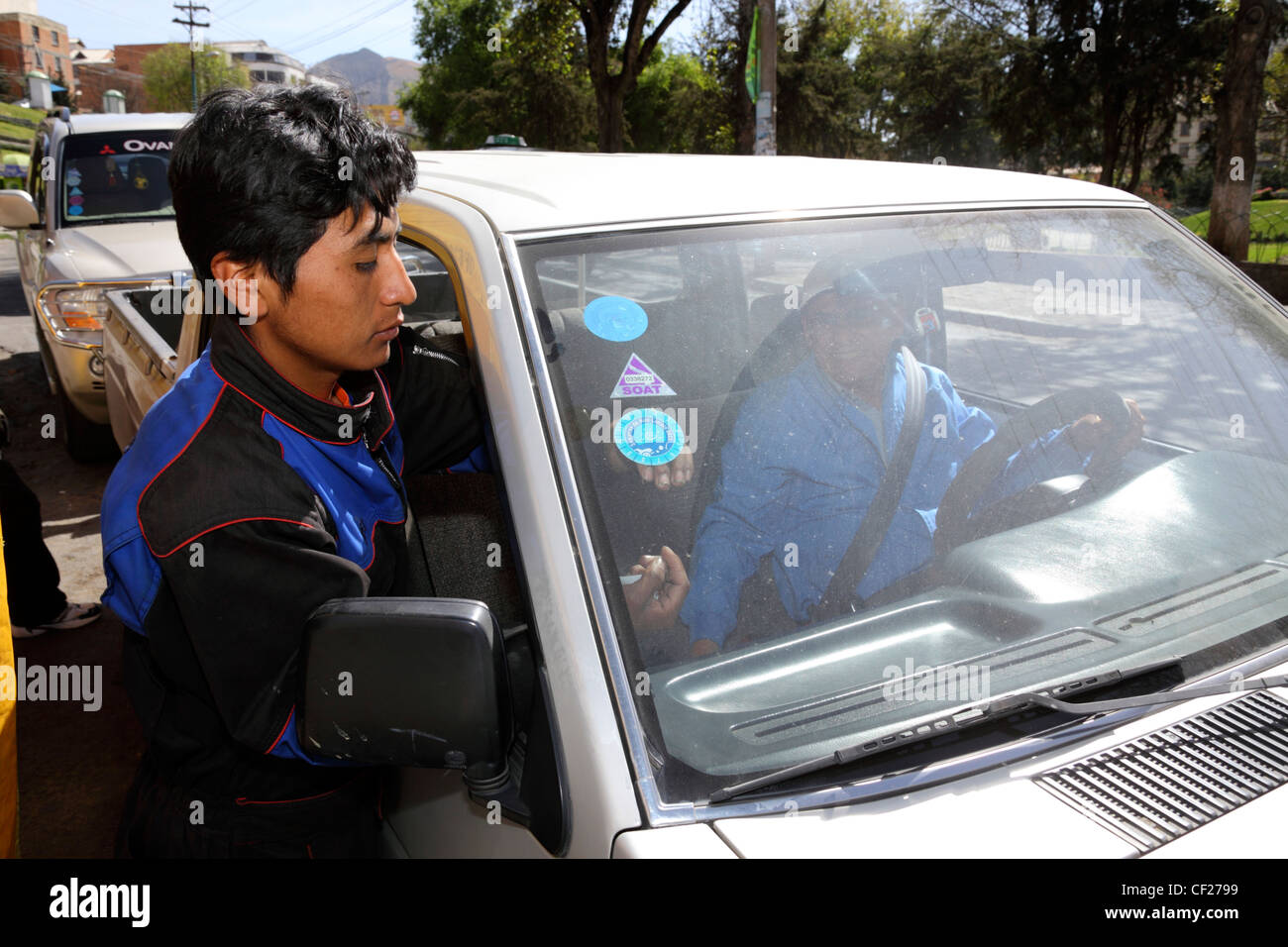 A car mechanic puts a sticker in the windscreen of a car to show it has ...