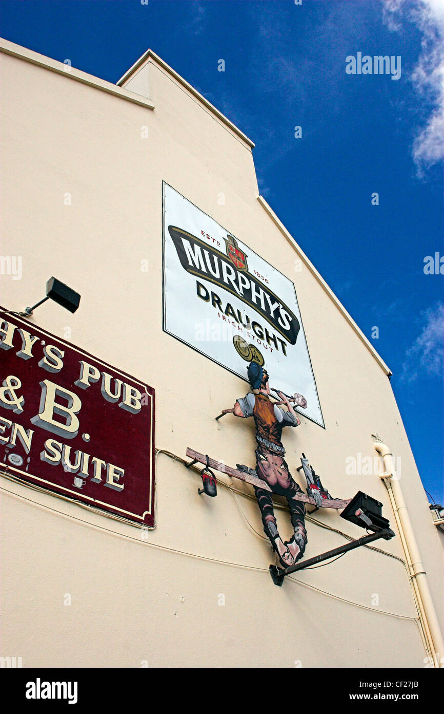 A large sign advertising Murphys stout on the side of a pub in Dingle ...