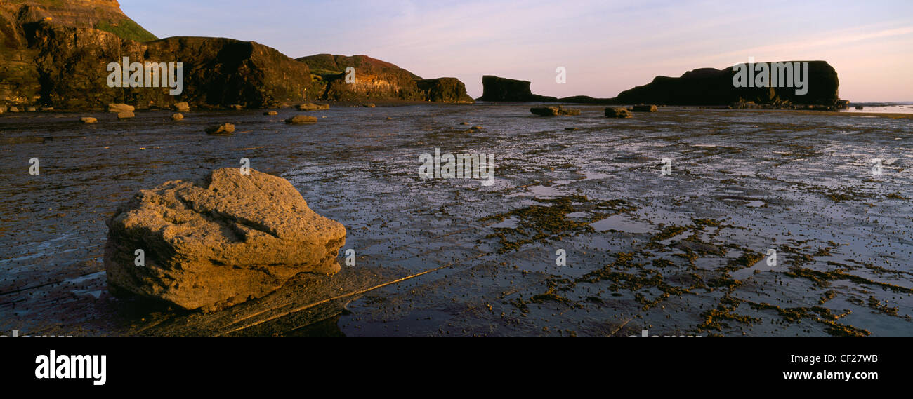 Morning light iluminates the coastline of Saltwick Bay Nab near Whitby ...