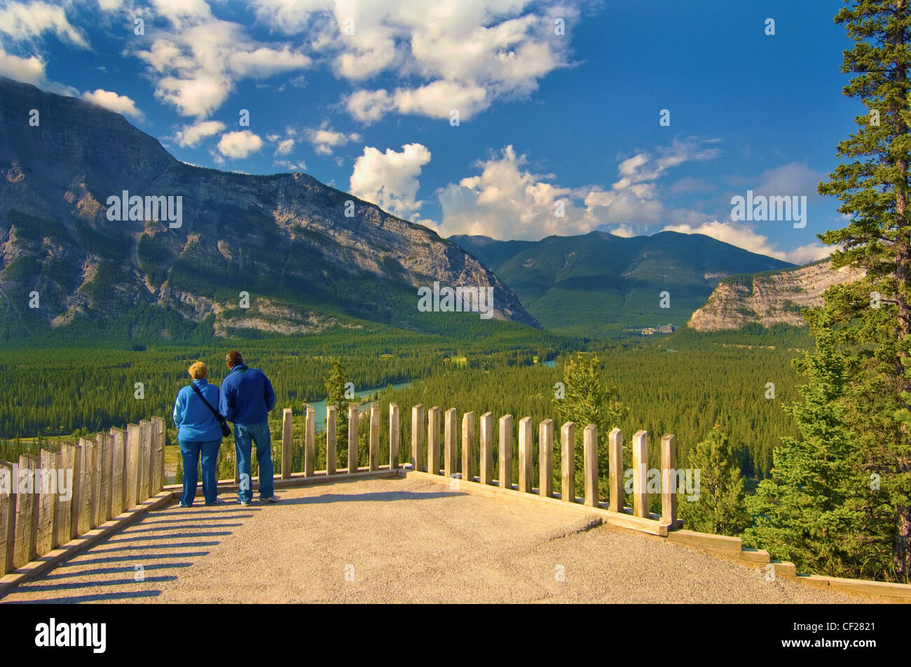 A Man And Woman Overlooking A Scenic View Of Banff National Park; Banff ...