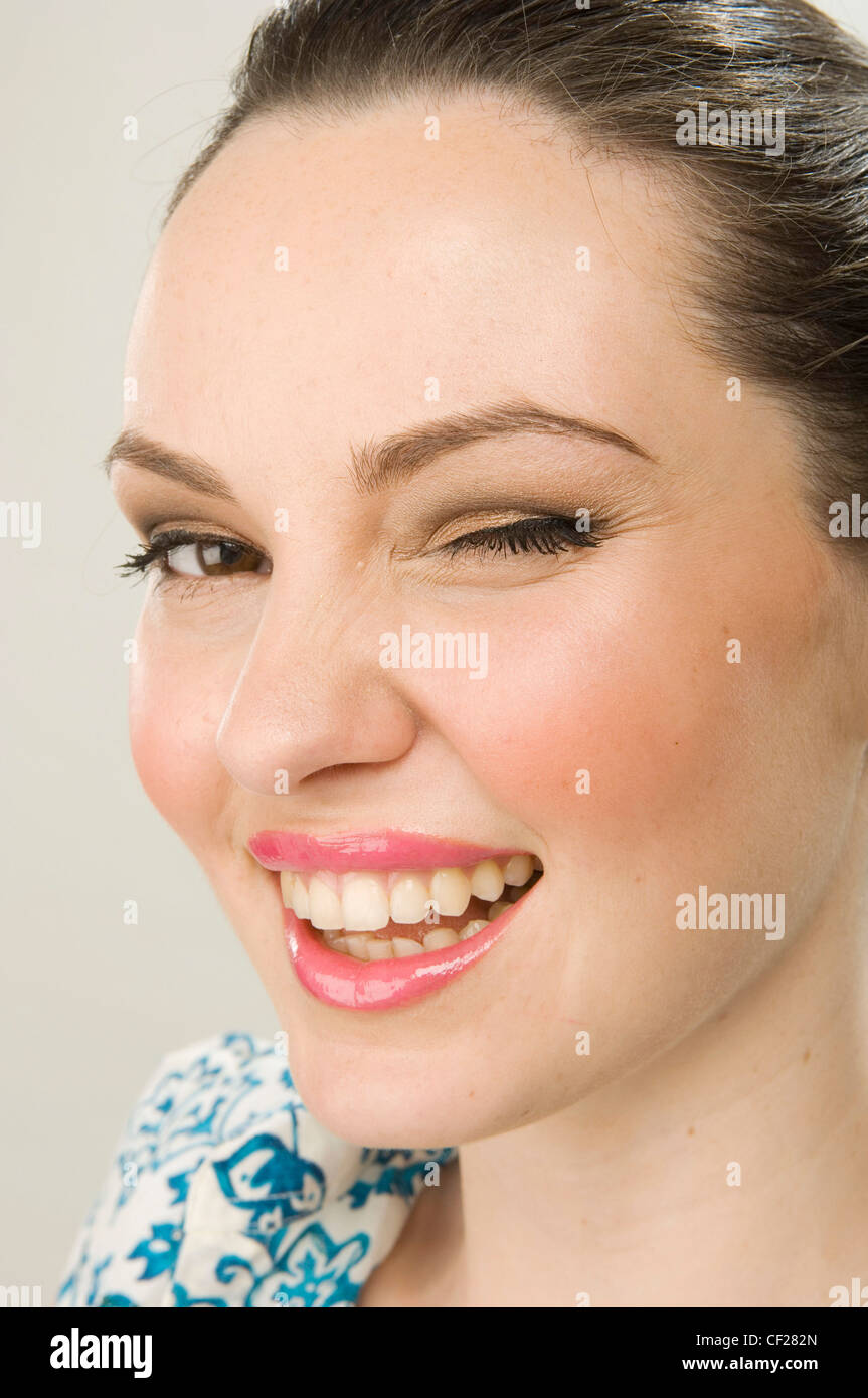Female winking to camera Stock Photo - Alamy