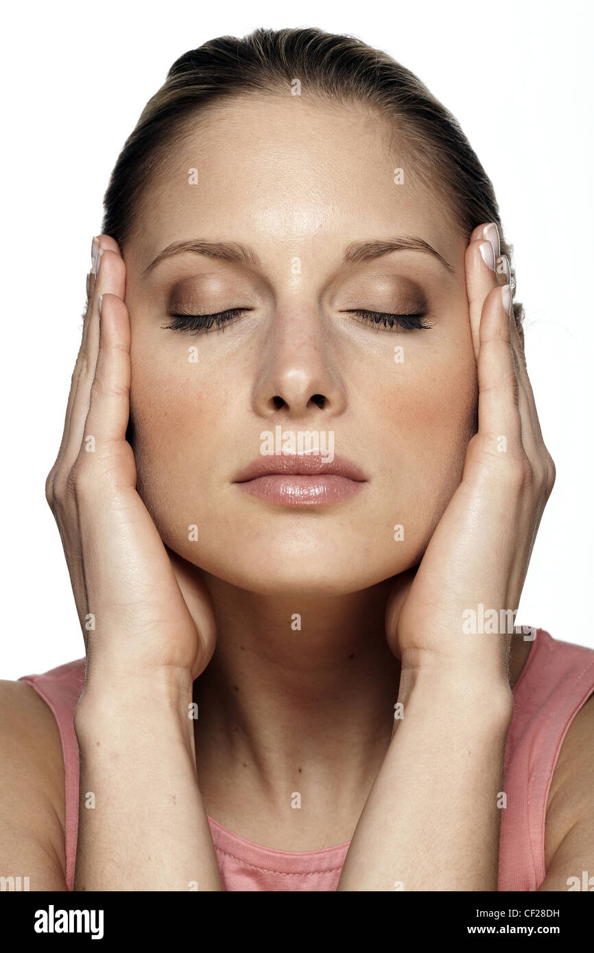 Female with hands on face Stock Photo - Alamy