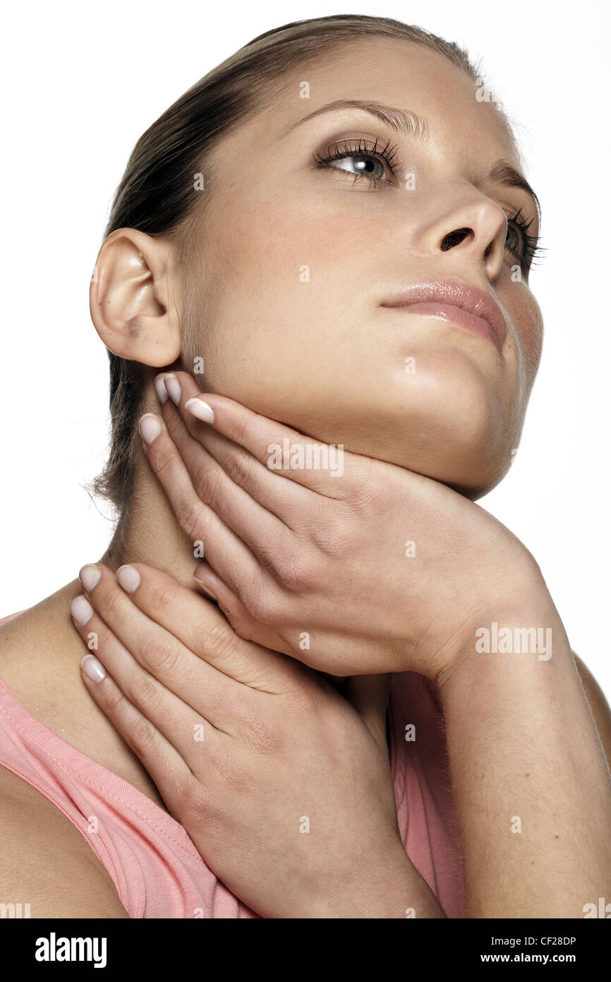 Female with both hands on neck Stock Photo - Alamy