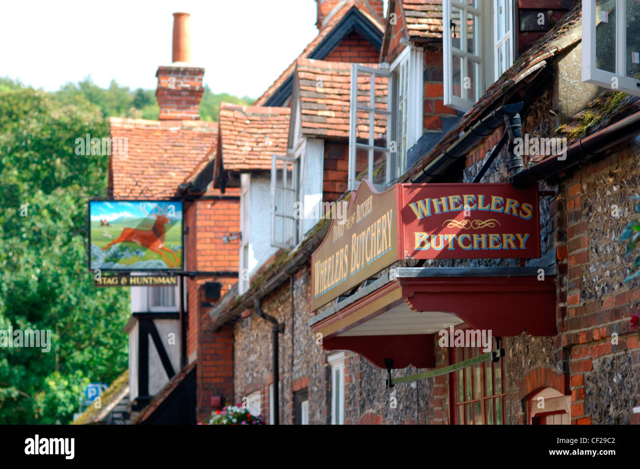Pub and butcher signs with houses at Hambleden Village. The name is ...