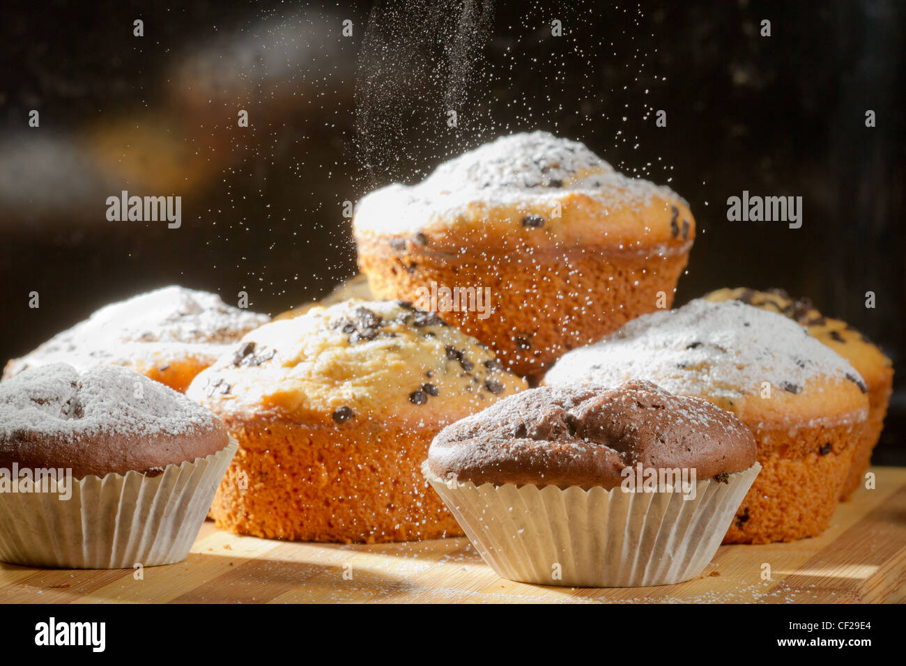 Falling caster sugar on vanilla muffin Stock Photo - Alamy