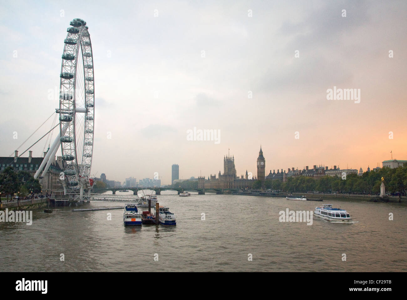 A view across the River Thames towards the London Eye and Houses of ...