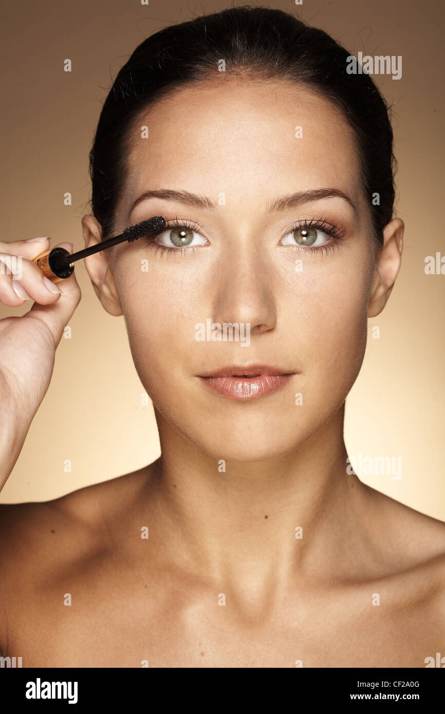 Female applying mascara Stock Photo - Alamy