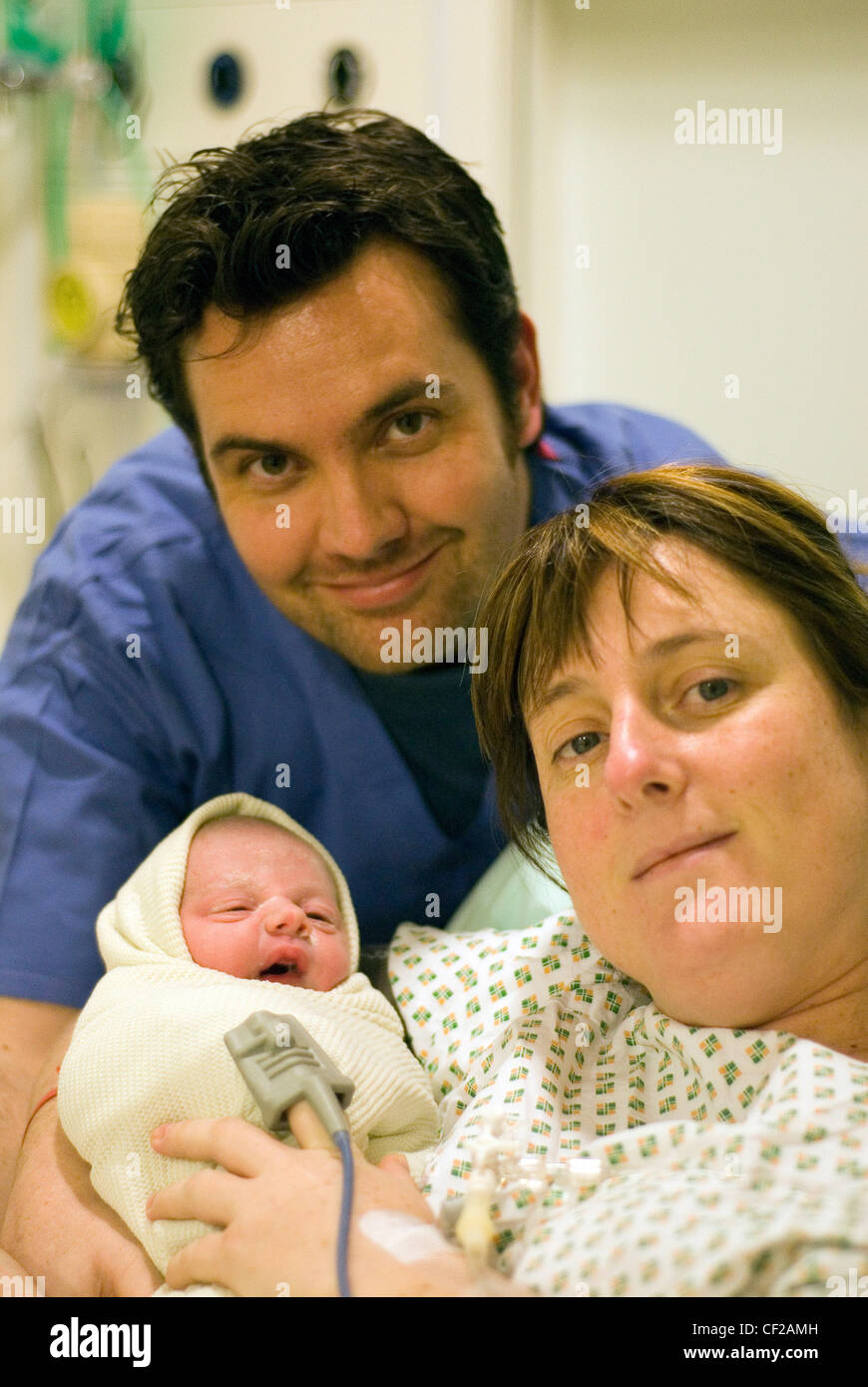 Male wearing blue hospital overalls, and female wearing a hospital gown ...