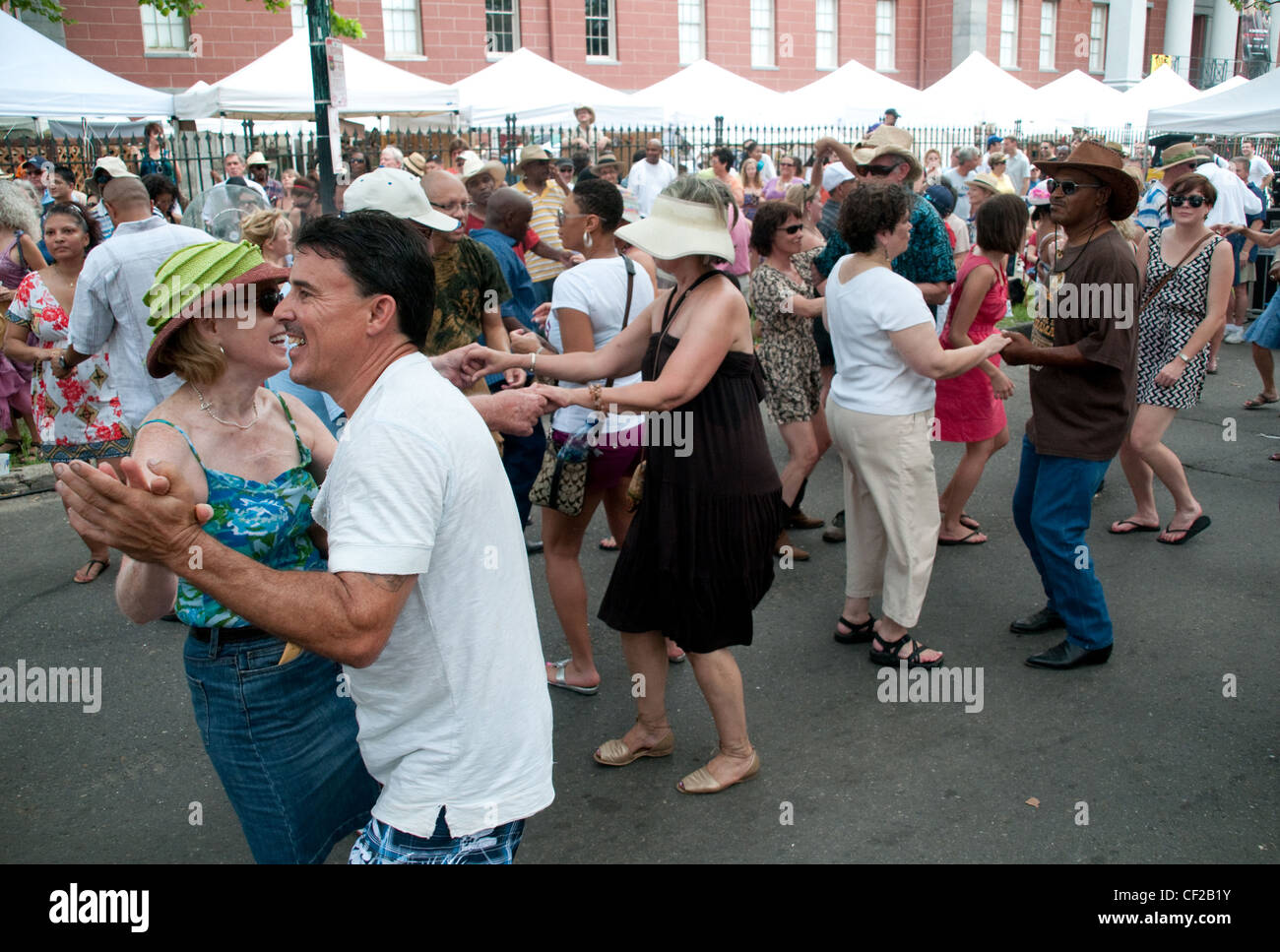 Local men and women residents dancing at a street party during a food ...