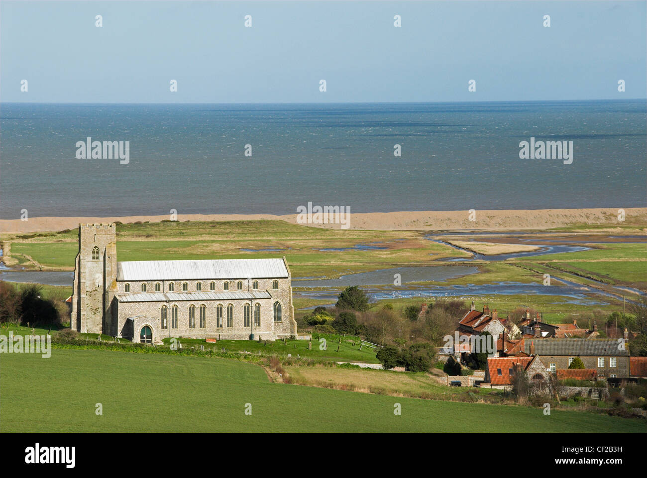 Salthouse church and village showing coastal freshmarsh and sea wall in ...