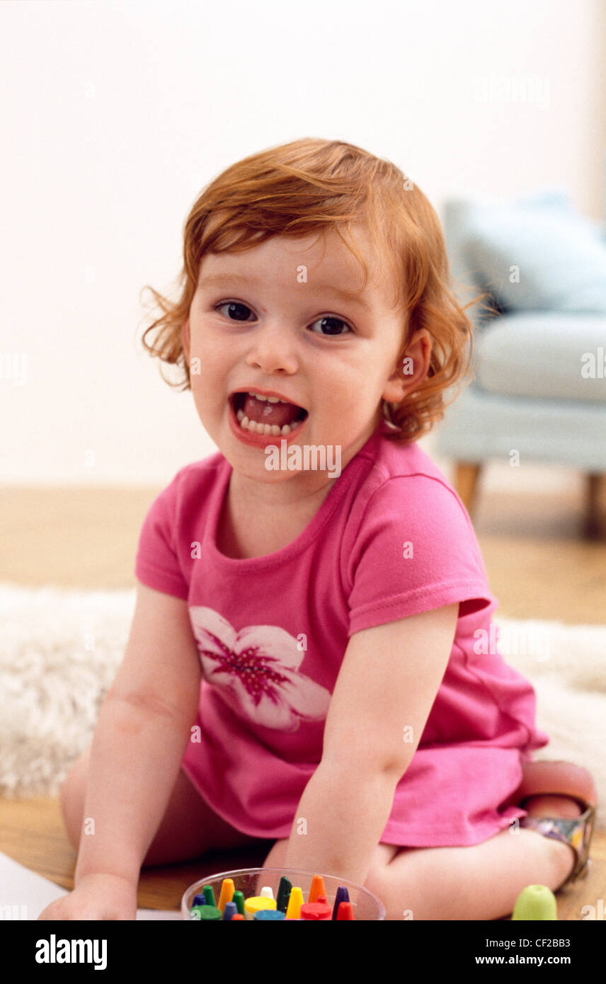 Female toddler ginger hair wearing a short pink dress and sandals ...