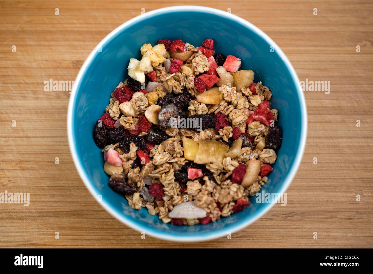 A blue bowl of cereal with dried fruit Stock Photo - Alamy