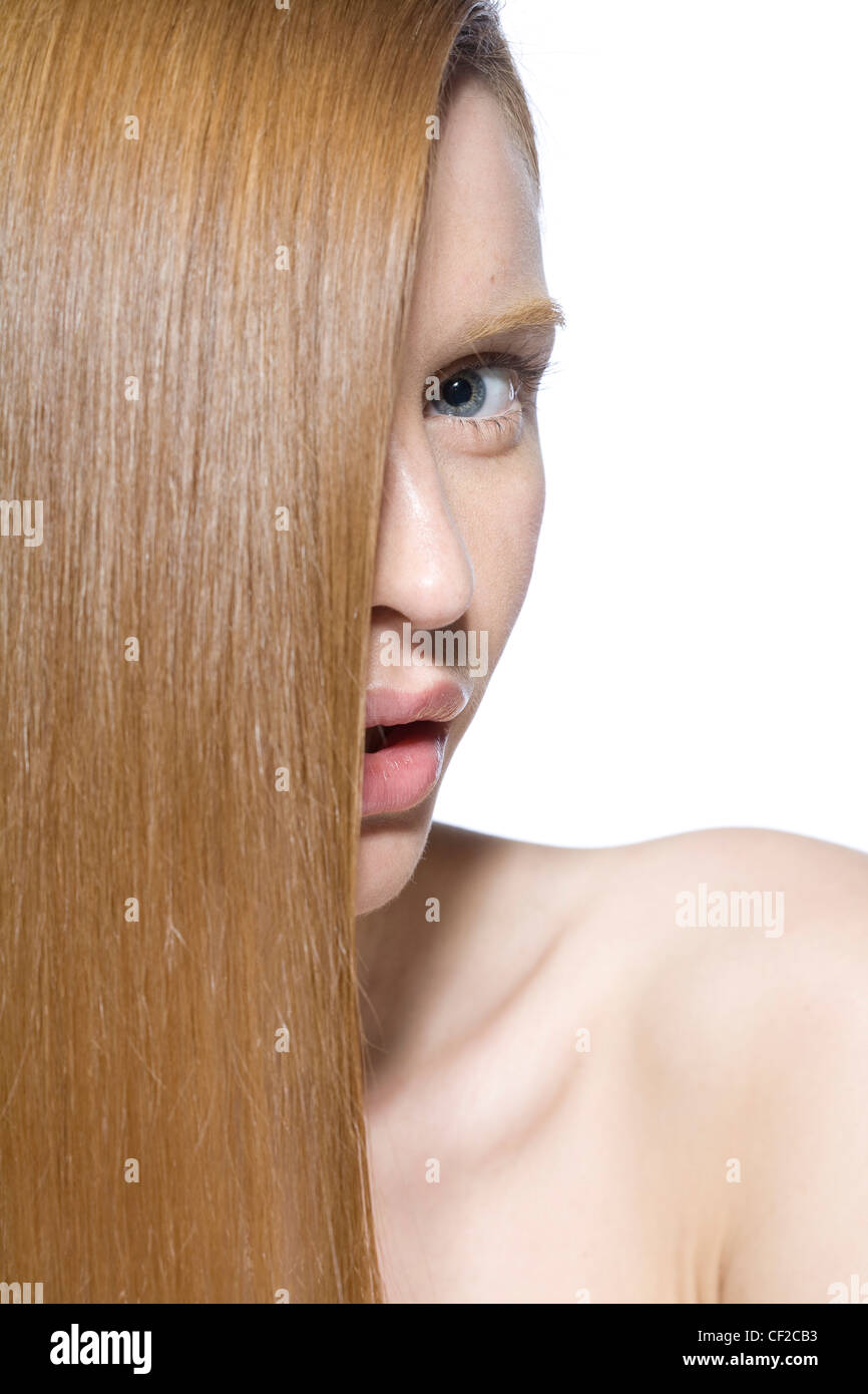 Side view of female with long straight fair hair over face, unsmiling ...