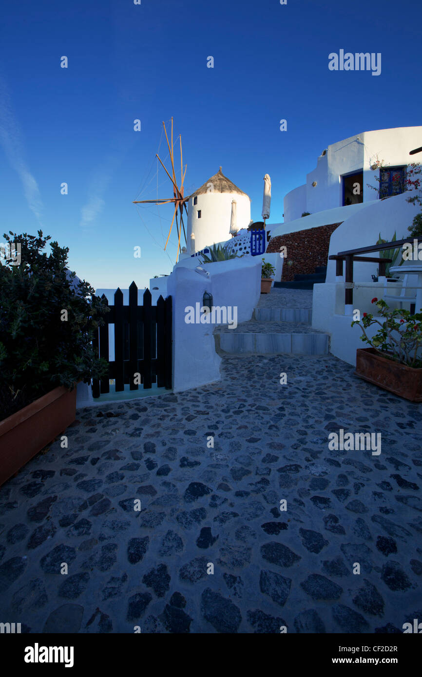 A view from a winding pathway towards a traditional windmill Stock ...