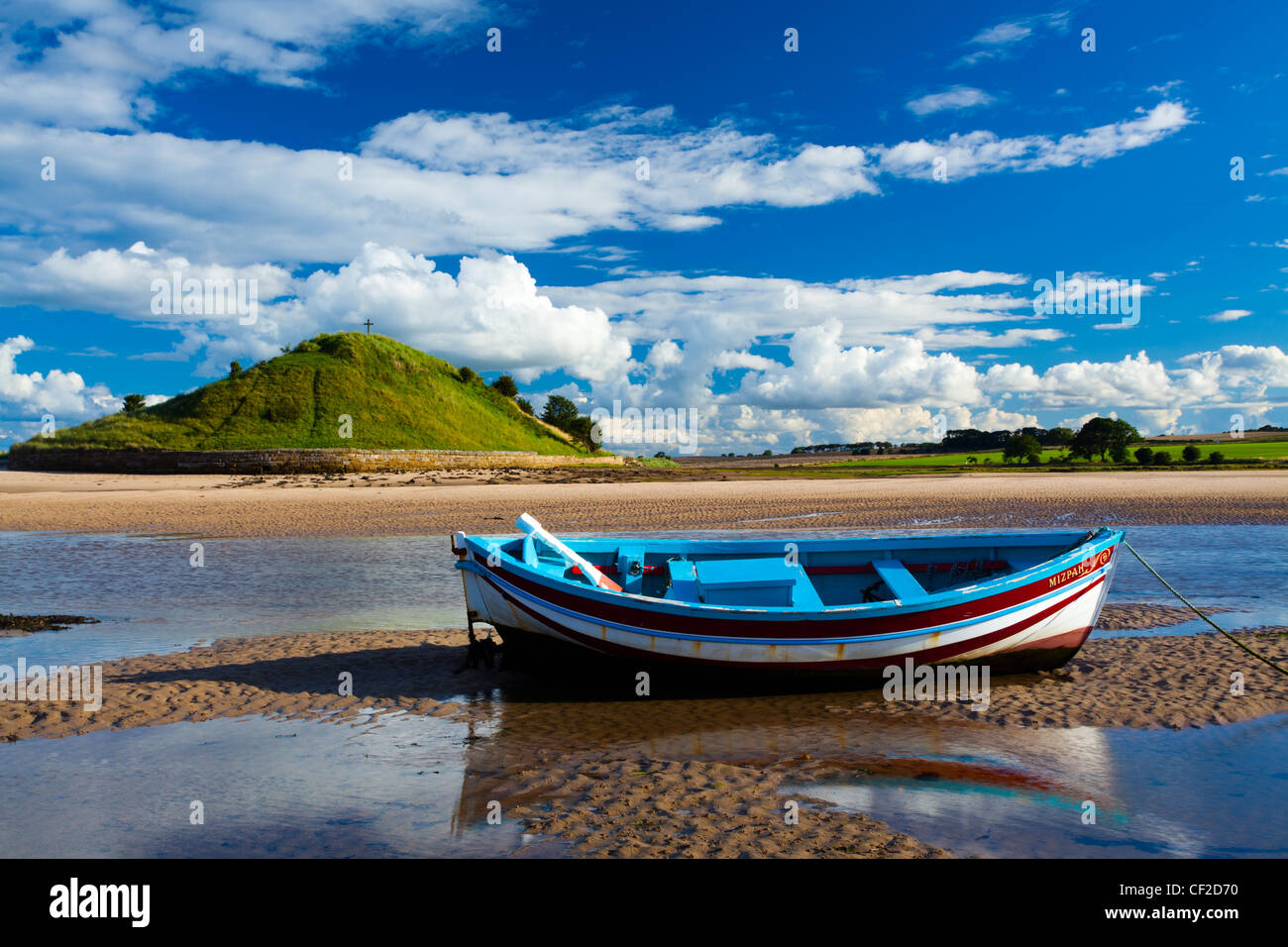 Boats on the tidal Aln Estuary at Alnmouth. The hill in the distance is ...