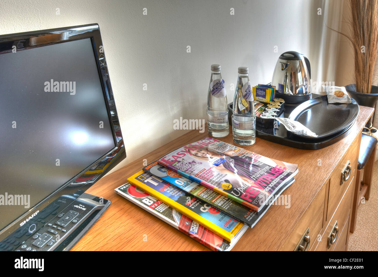 A hotel room interior showing close up of the items on top of a chest ...