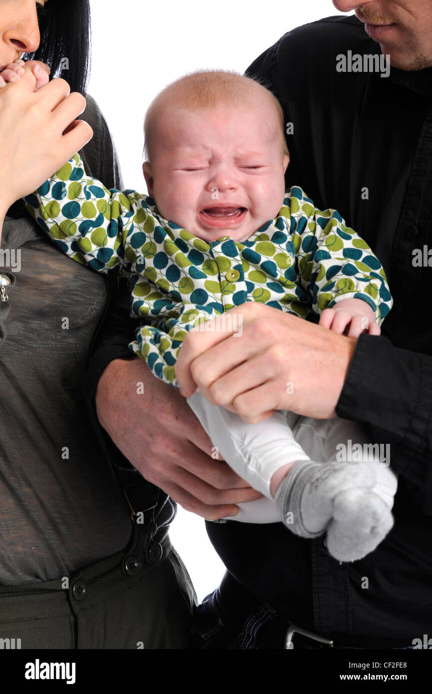 parents trying to comfort their crying baby Stock Photo - Alamy