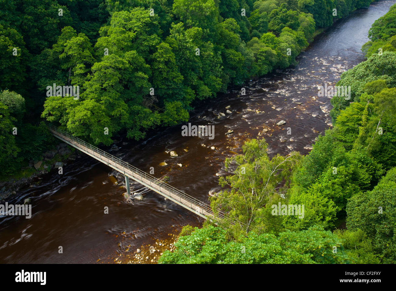 Lambley footbridge crossing the River South Tyne as it flows through ...