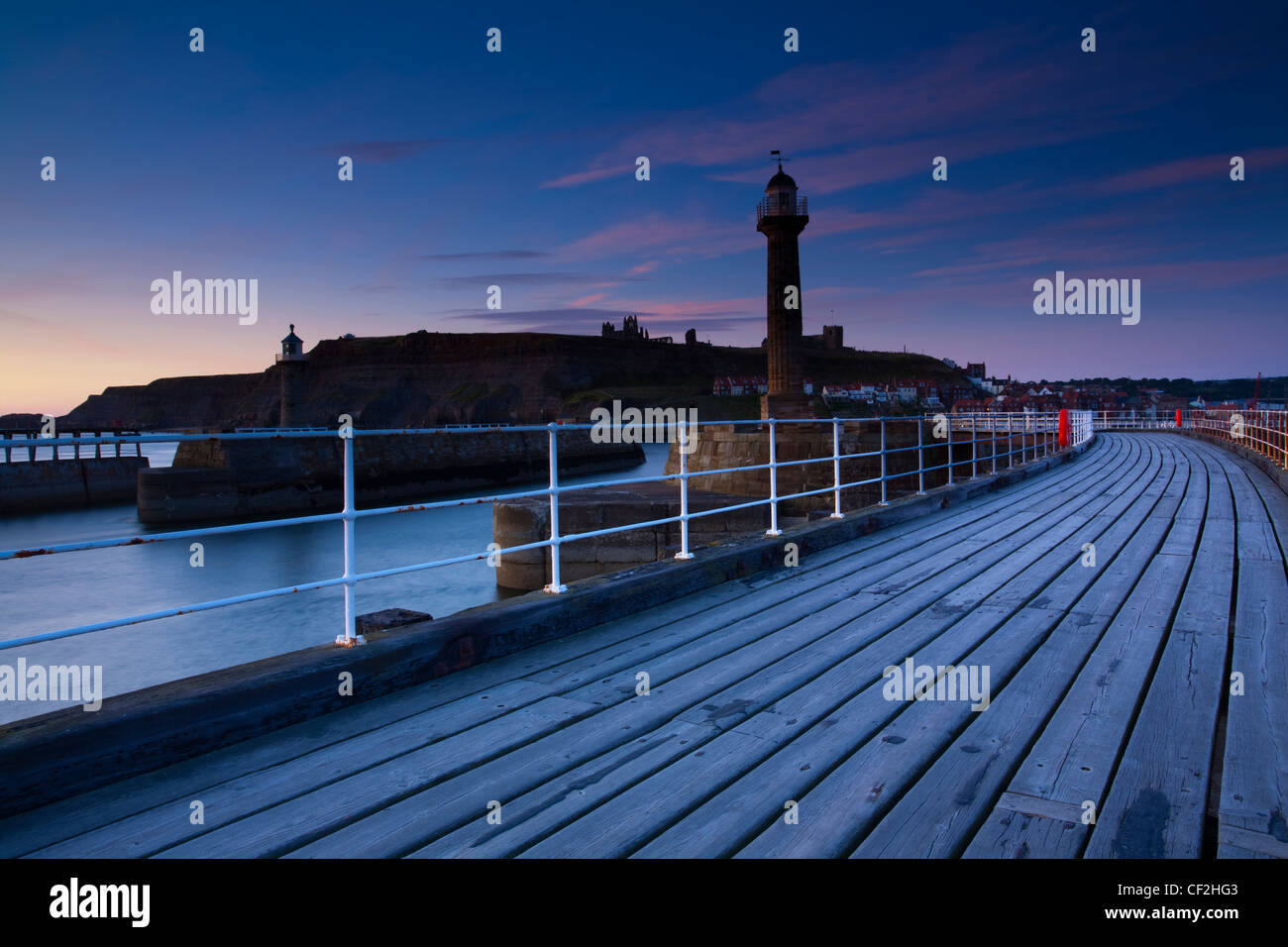 Looking from the entrance piers of Whitby Harbour at dawn Stock Photo ...