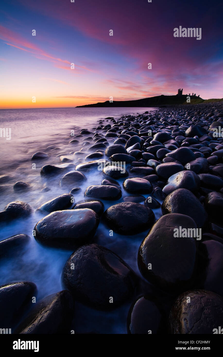 Waves crash againt the sea sculptured rocks dominating the coastline of ...